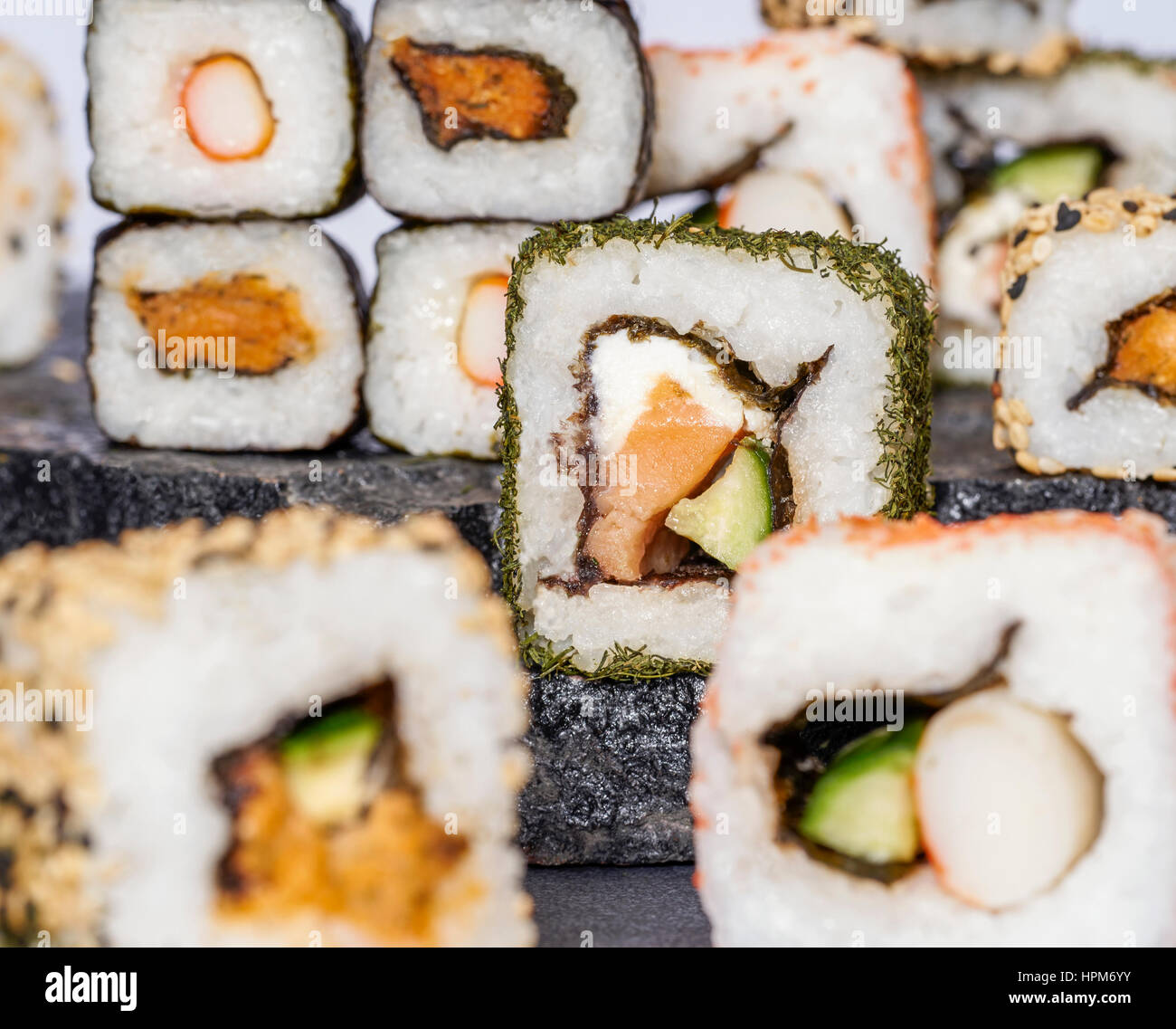 various sushi dishes on dark grey stone surface Stock Photo - Alamy