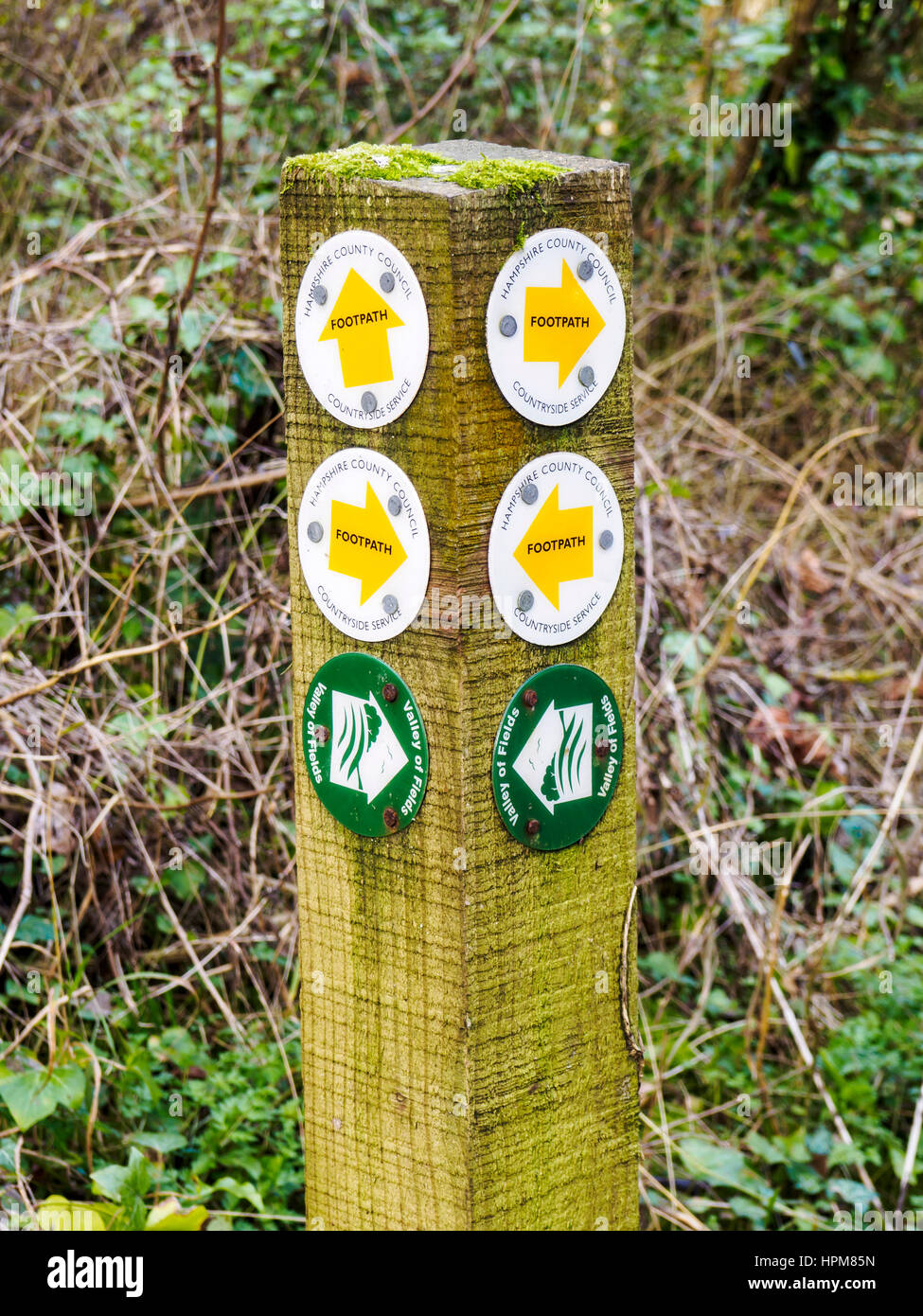 Marker post with roundel arrows showing footpath directions on the ...