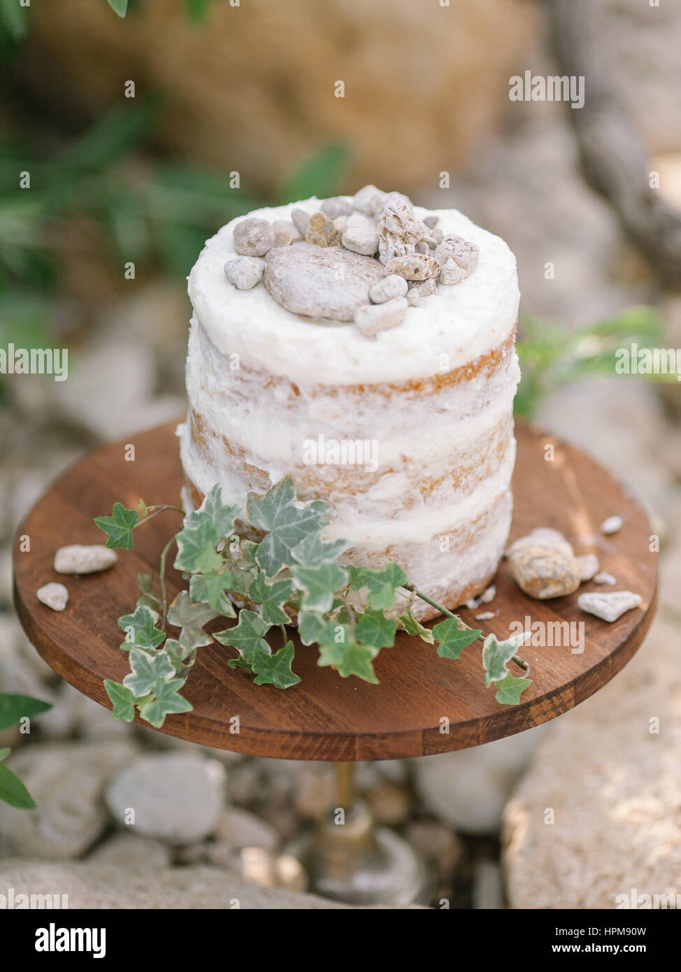 naced cake whith white cream on a wooden substrate decorated with ...