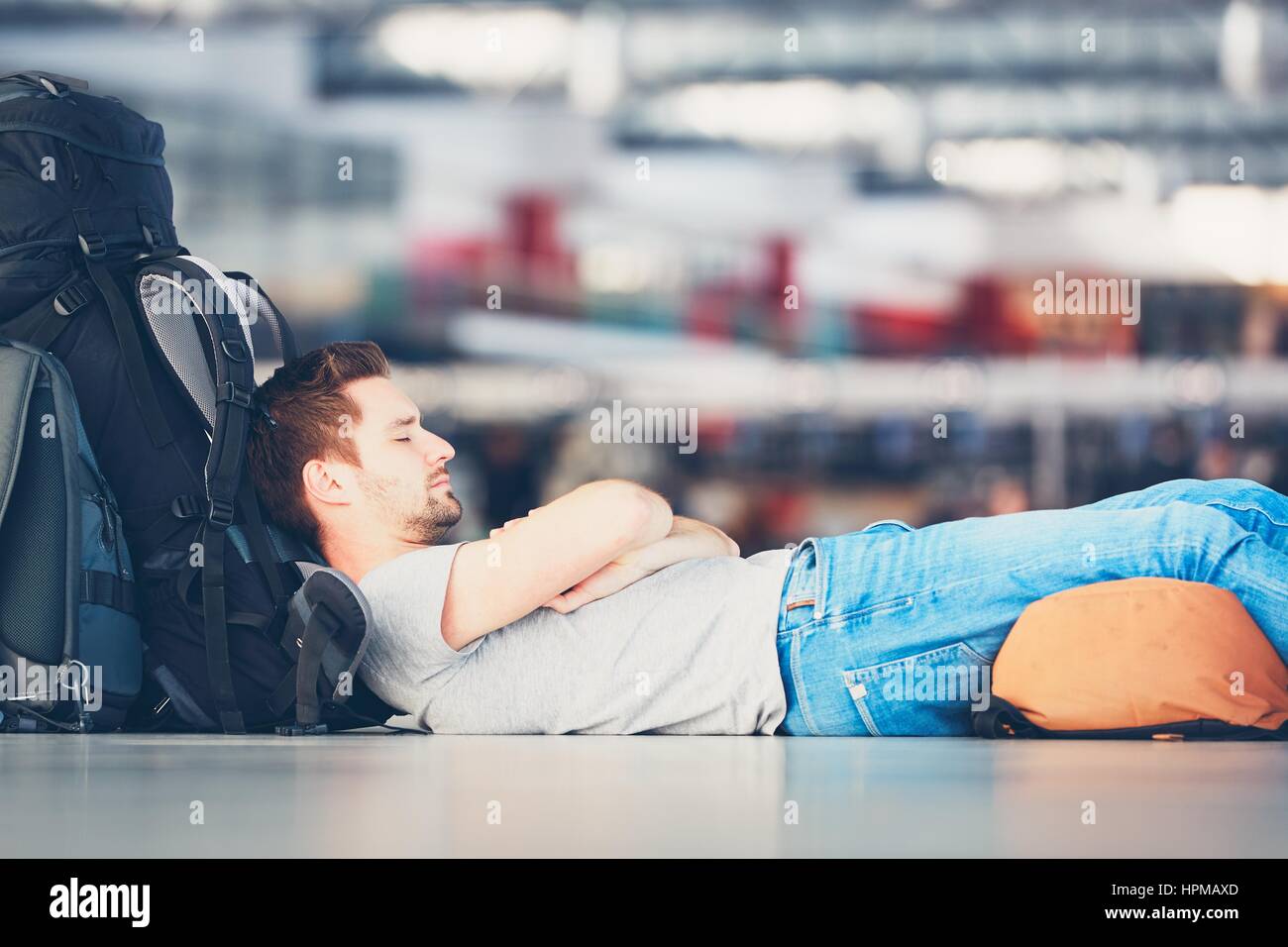 Traveler waiting at the airport departure area for his delay flight ...