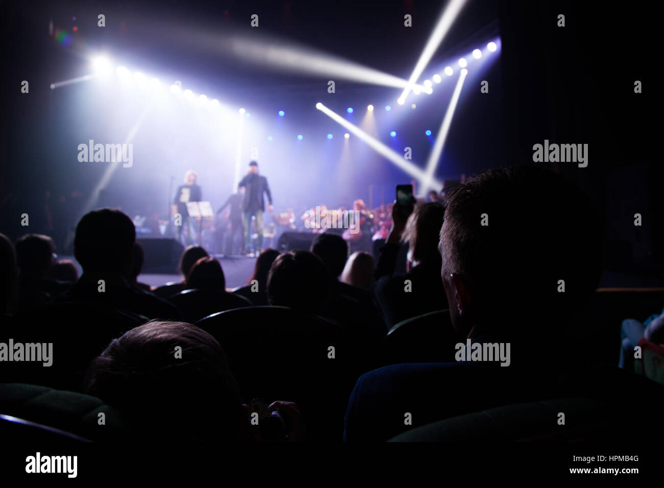 The audience at a concert on background of scene Stock Photo - Alamy