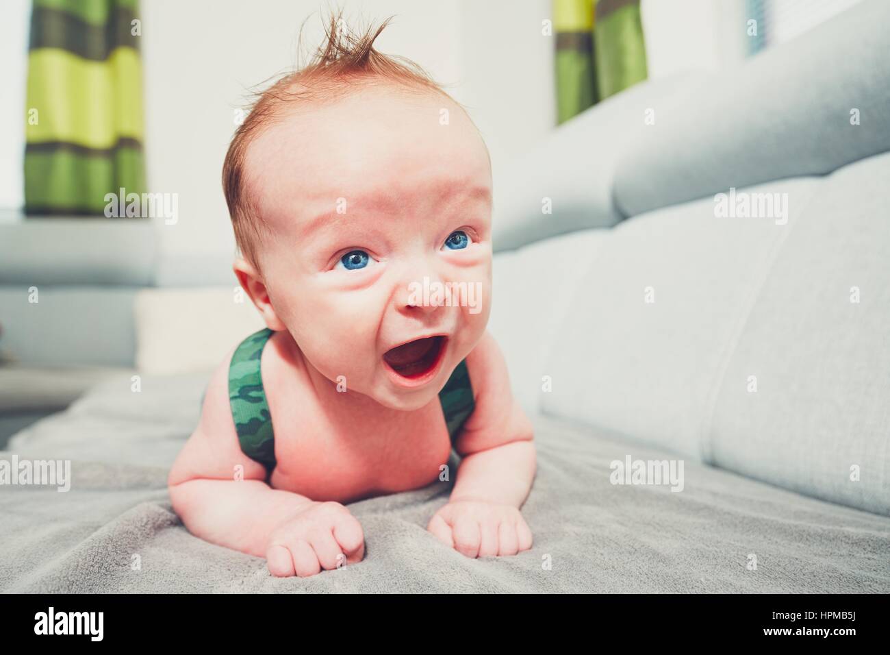 Little boy crawling on the sofa at home Stock Photo - Alamy