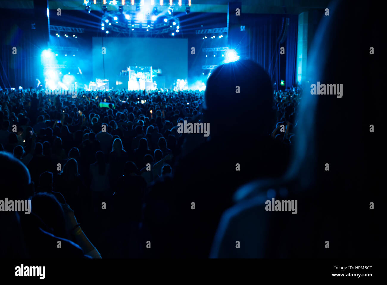 The audience watching the concert on stage Stock Photo - Alamy