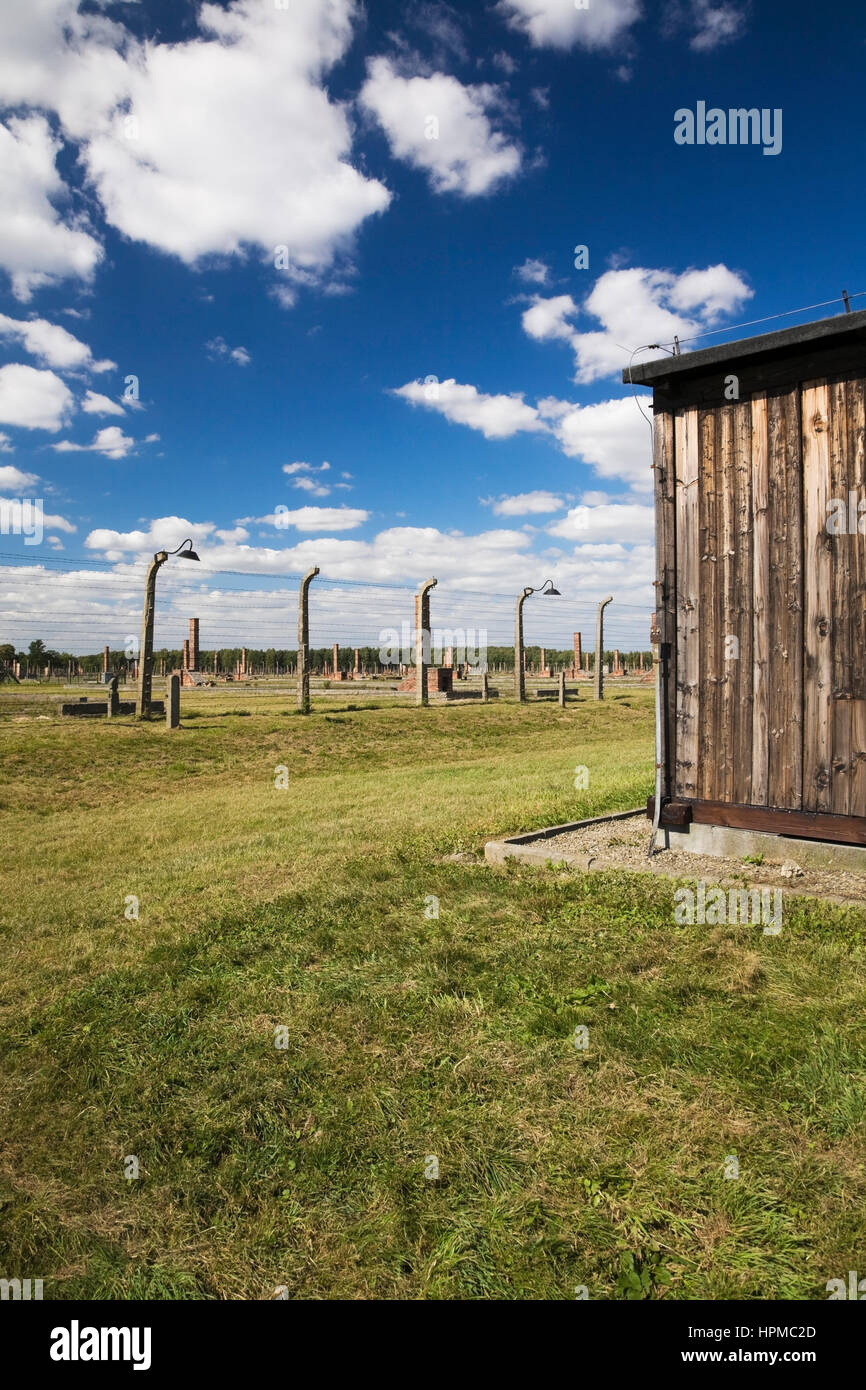 Dormitory building and barbed wire electric fence at Auschwitz II ...
