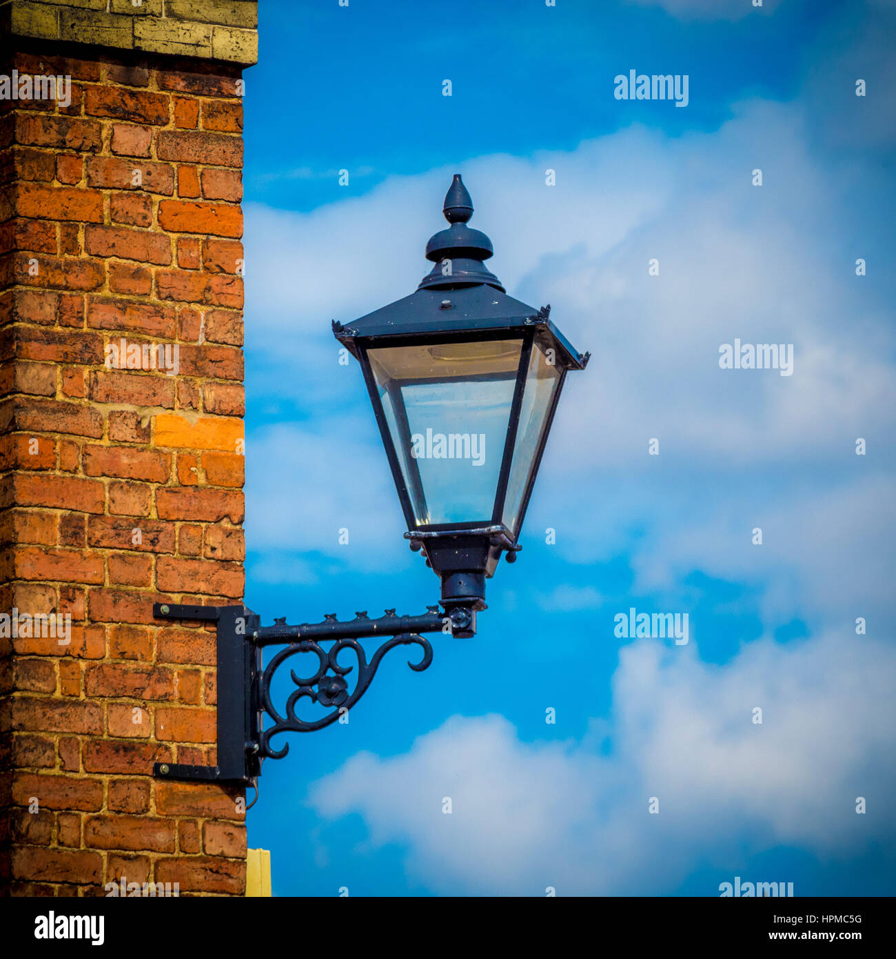 Traditional street Light on corner of brickwork on Clock Tower building ...