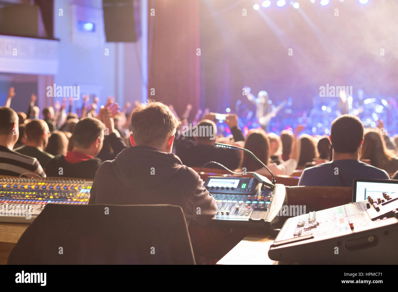 Soundman working on the mixing console in concert hall Stock Photo - Alamy