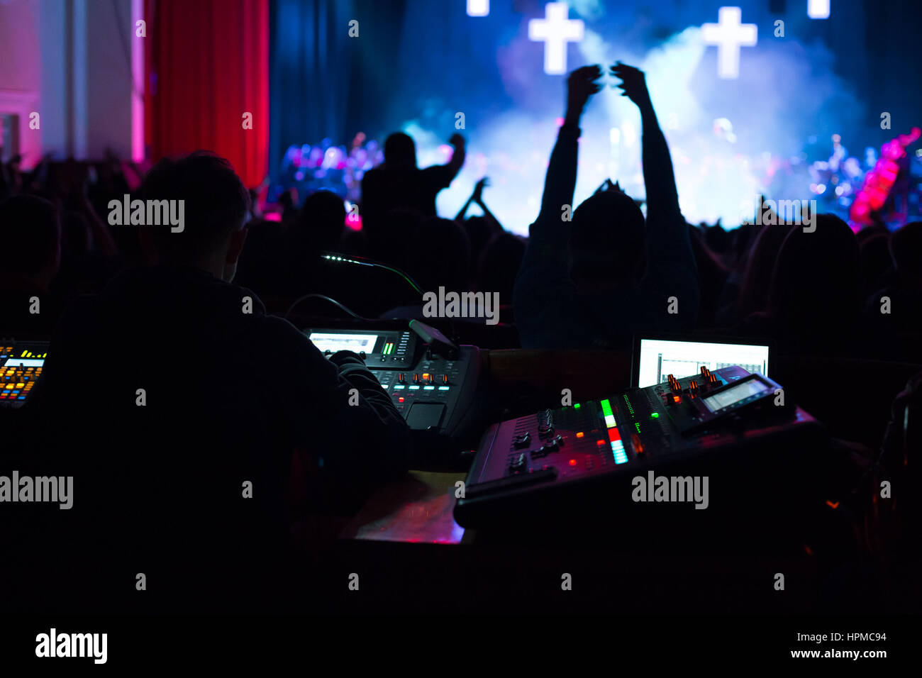 Soundman working on the mixing console in concert hall Stock Photo - Alamy
