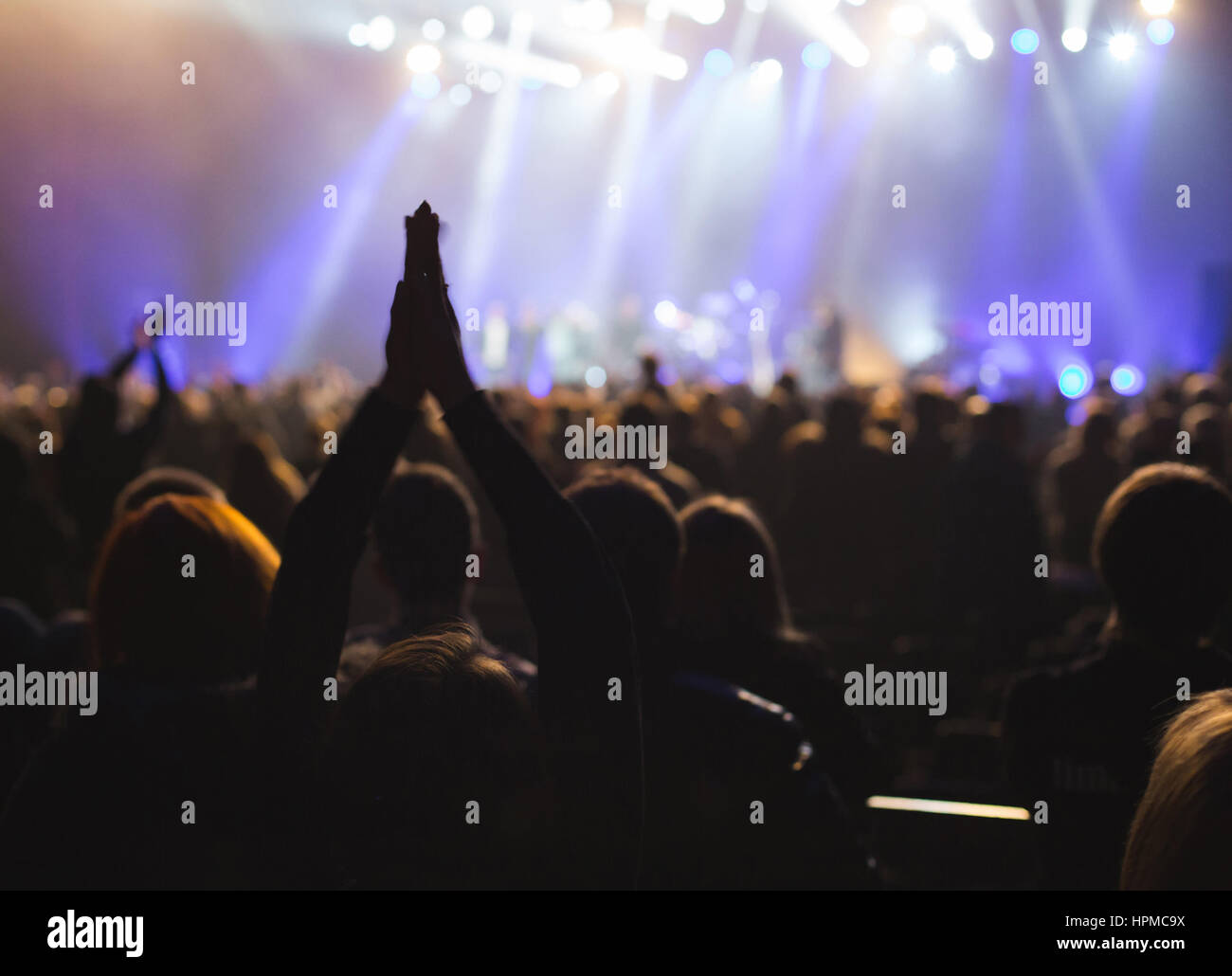 The audience applauded by the stage artist. They shines the spotlight ...