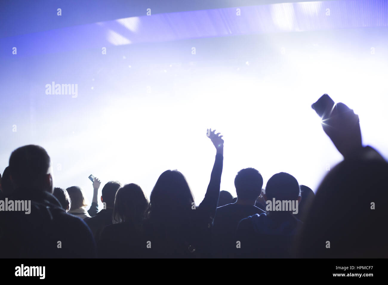 The audience watching the concert on stage Stock Photo - Alamy