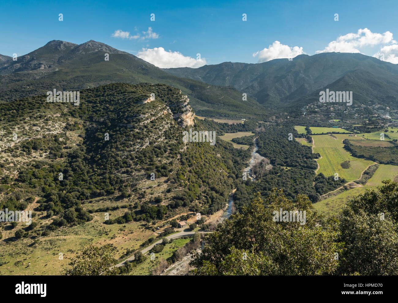 Steep cliffs of an escarpment dropping to a river valley in the Nebbiu ...