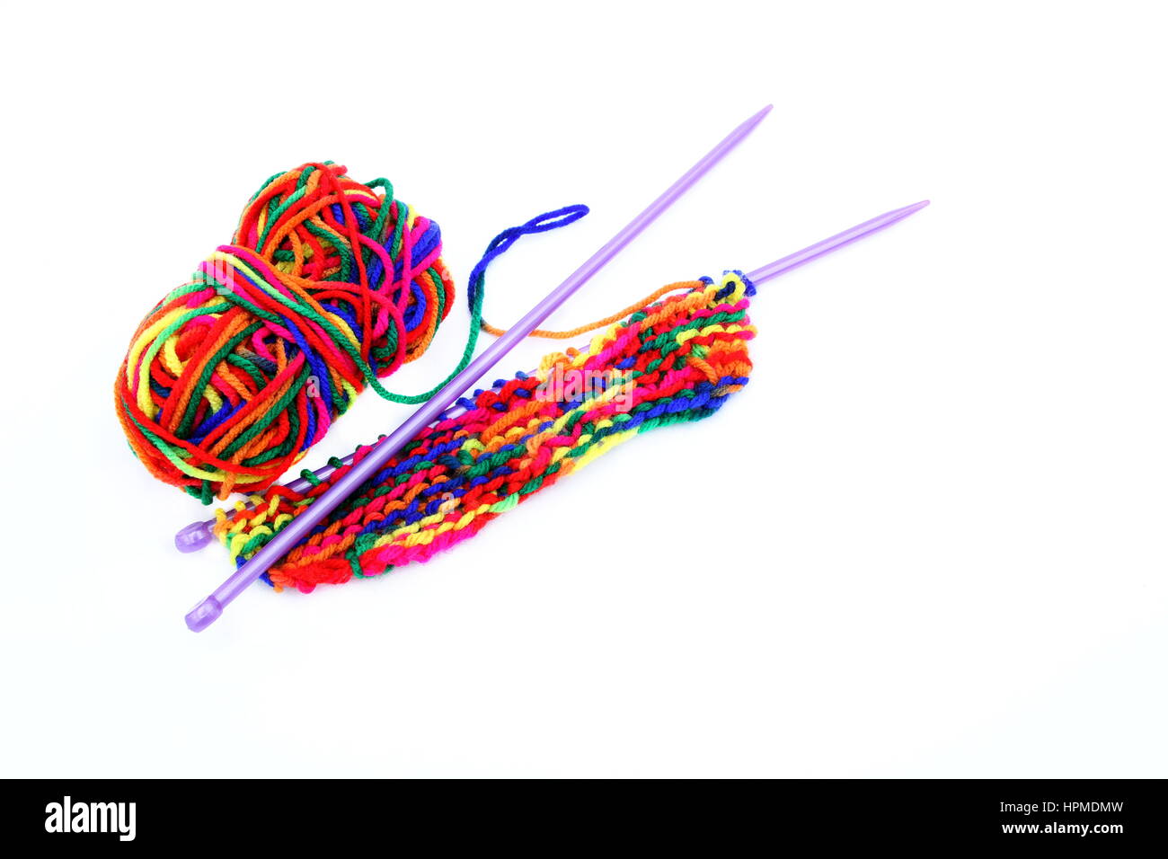 Bright multi-coloured colorful knitting wool or yarn with knitting ...