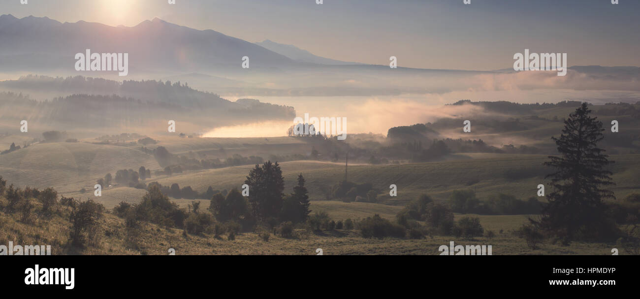 Misty morning landscape with mountain lake Stock Photo - Alamy