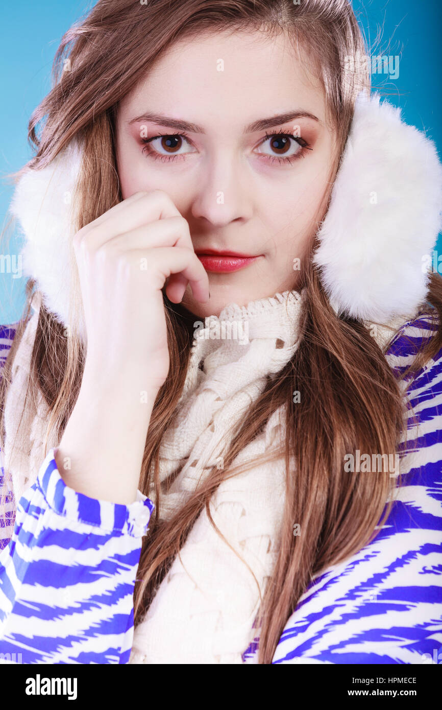 Teenage girl wearing fluffy white earmuff in winter fashion, cold time ...