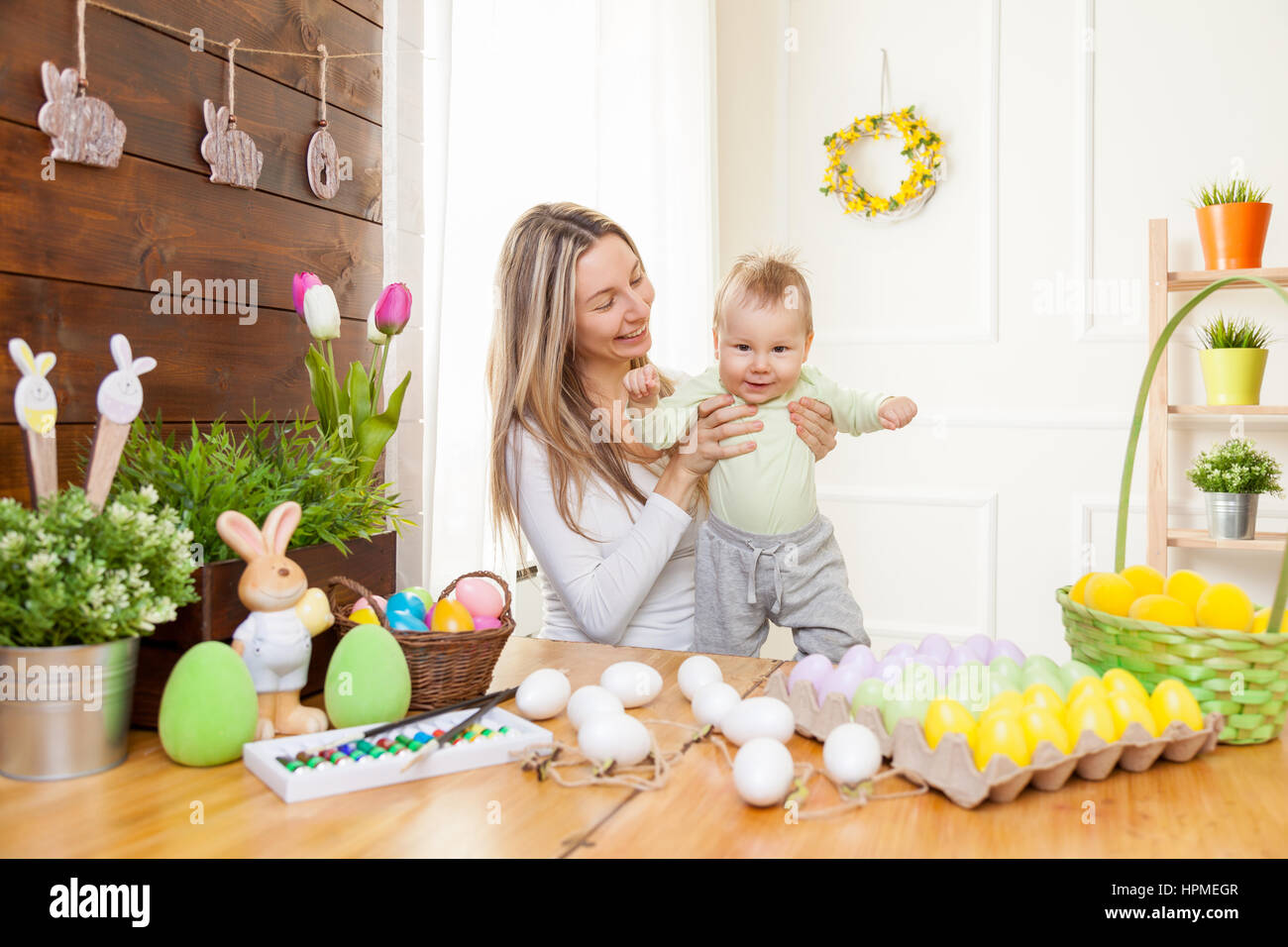 Happy Mother and her cute little child celebrating Easter at home Stock ...