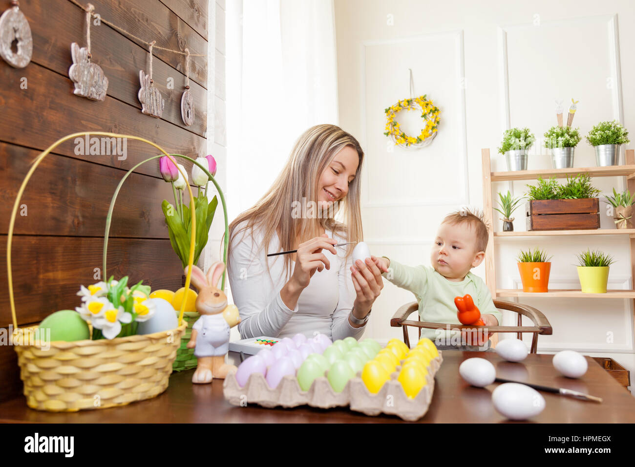 Easter concept. Happy mother and her cute child getting ready for ...