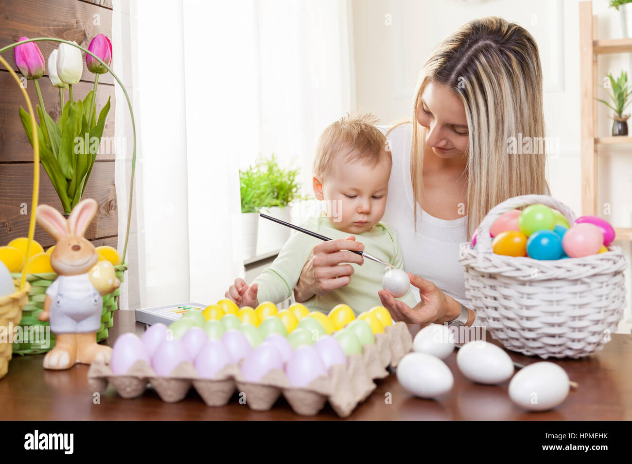 Easter concept. Happy mother and her cute child getting ready for ...