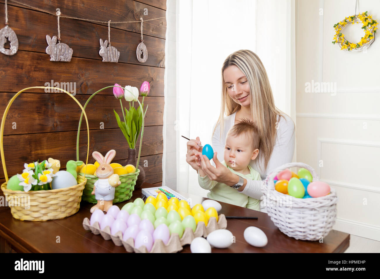 Easter concept. Happy mother and her cute child getting ready for ...