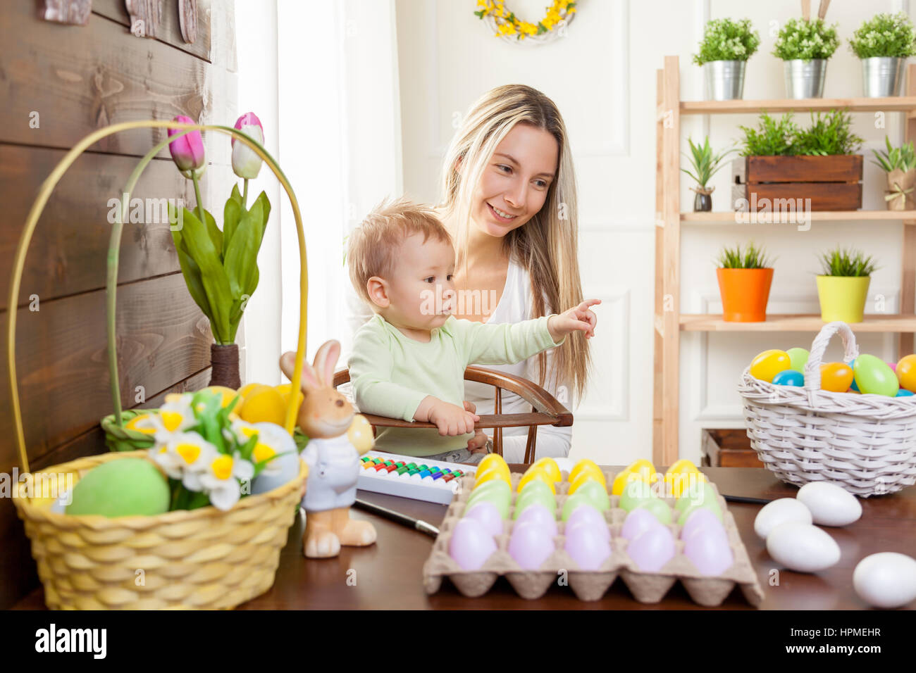 Easter concept. Happy mother and her cute child getting ready for ...