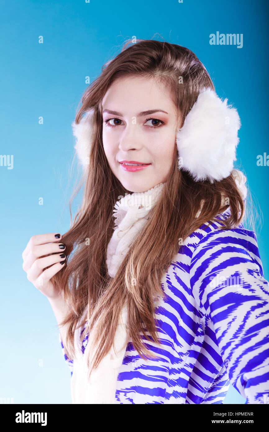 Teenage girl wearing fluffy white earmuff in winter fashion, cold time ...