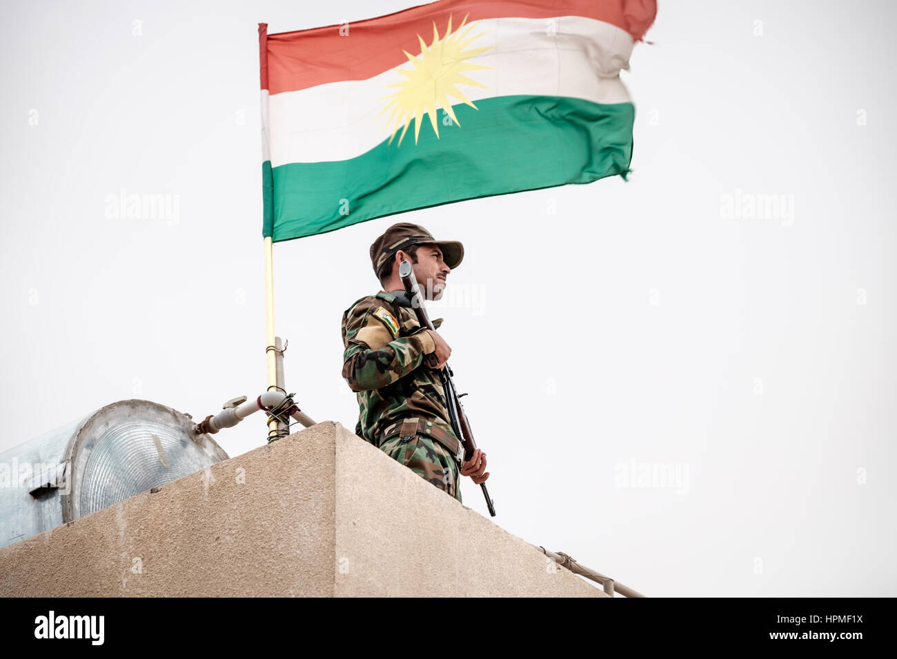 Yazidi Peshmerga stand guard on the roof of Qassim Shesho’s Brigade HQ ...