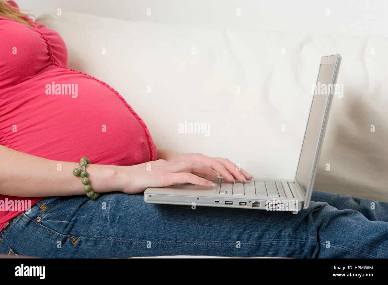 Pregnant woman typing on the computer Stock Photo - Alamy