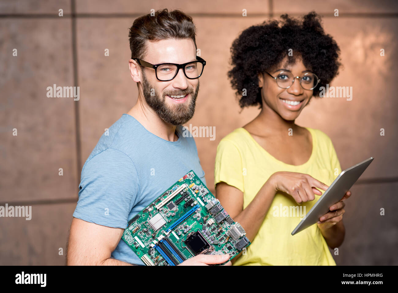 Programmers with computer motherboard Stock Photo - Alamy