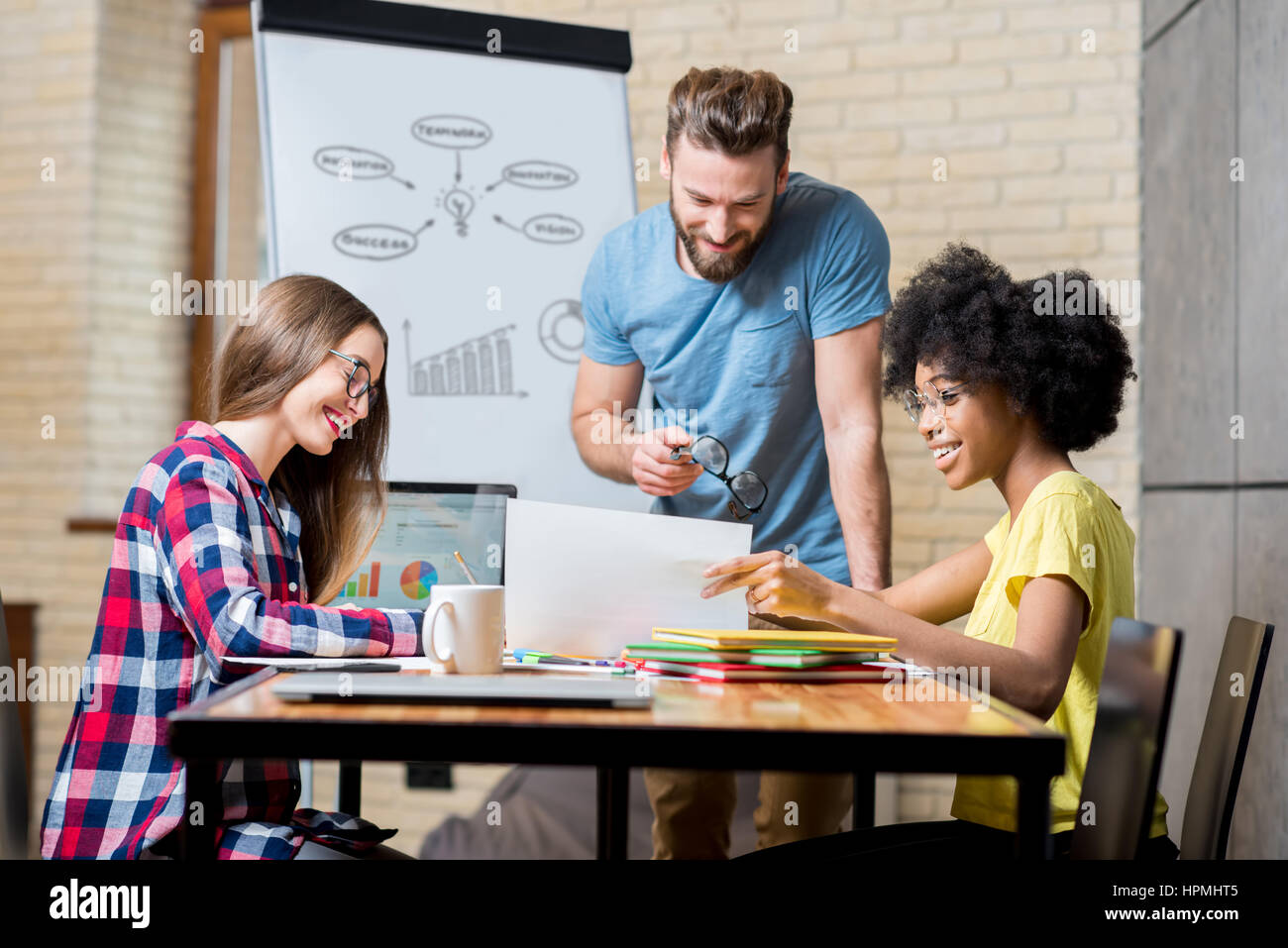 Coworkers working indoors Stock Photo - Alamy
