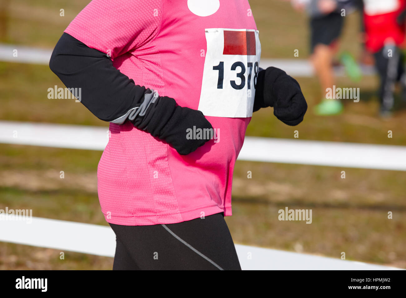 Young heavy female athletic runner on a race. Outdoor circuit ...