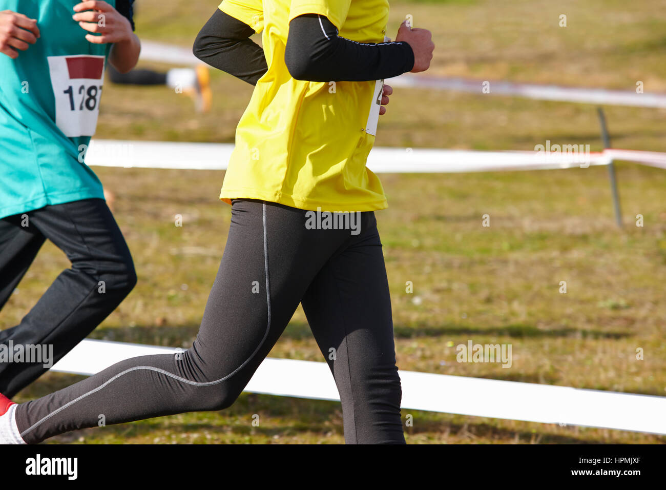 Young athletic runners on a cross country race. Outdoor circuit ...