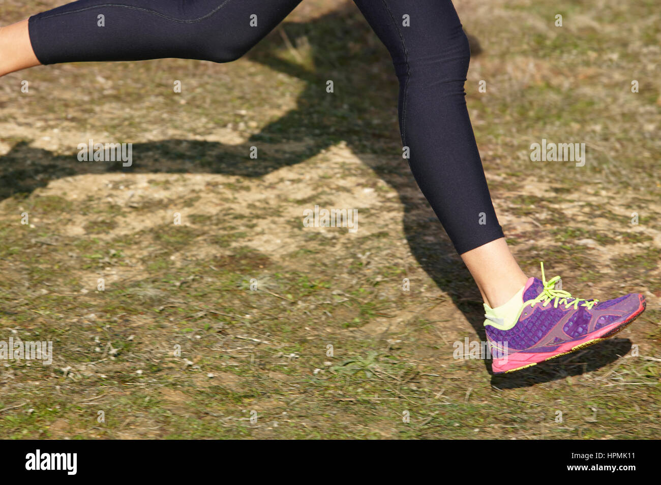 Female athletic runner legs detail. Outdoor circuit. Horizontal Stock ...