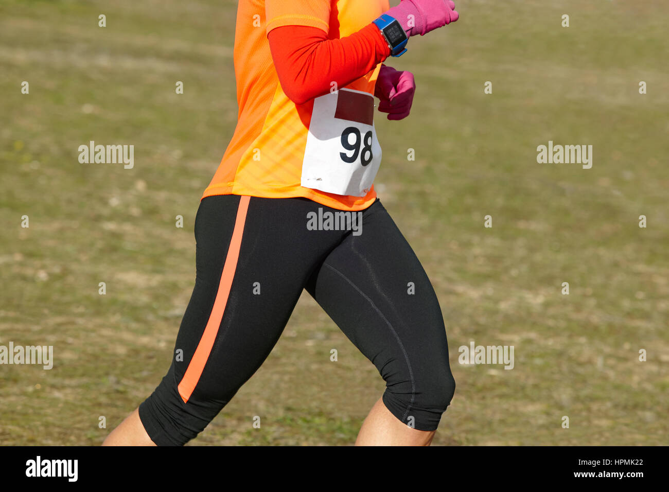 Female athletic runner on a race. Outdoor circuit. Horizontal Stock ...