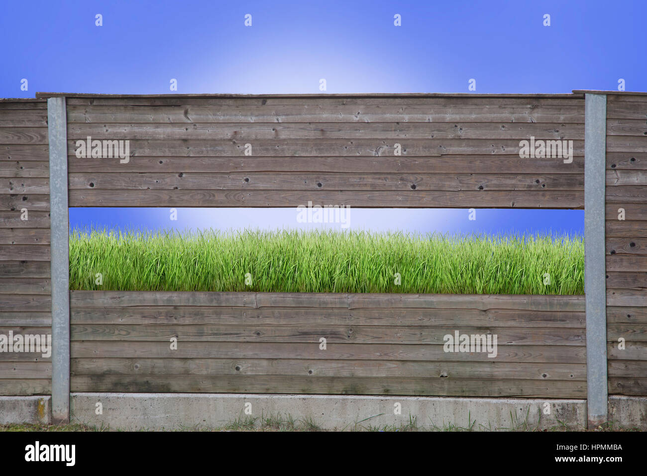 wall with viewon grass field from missing part Stock Photo - Alamy