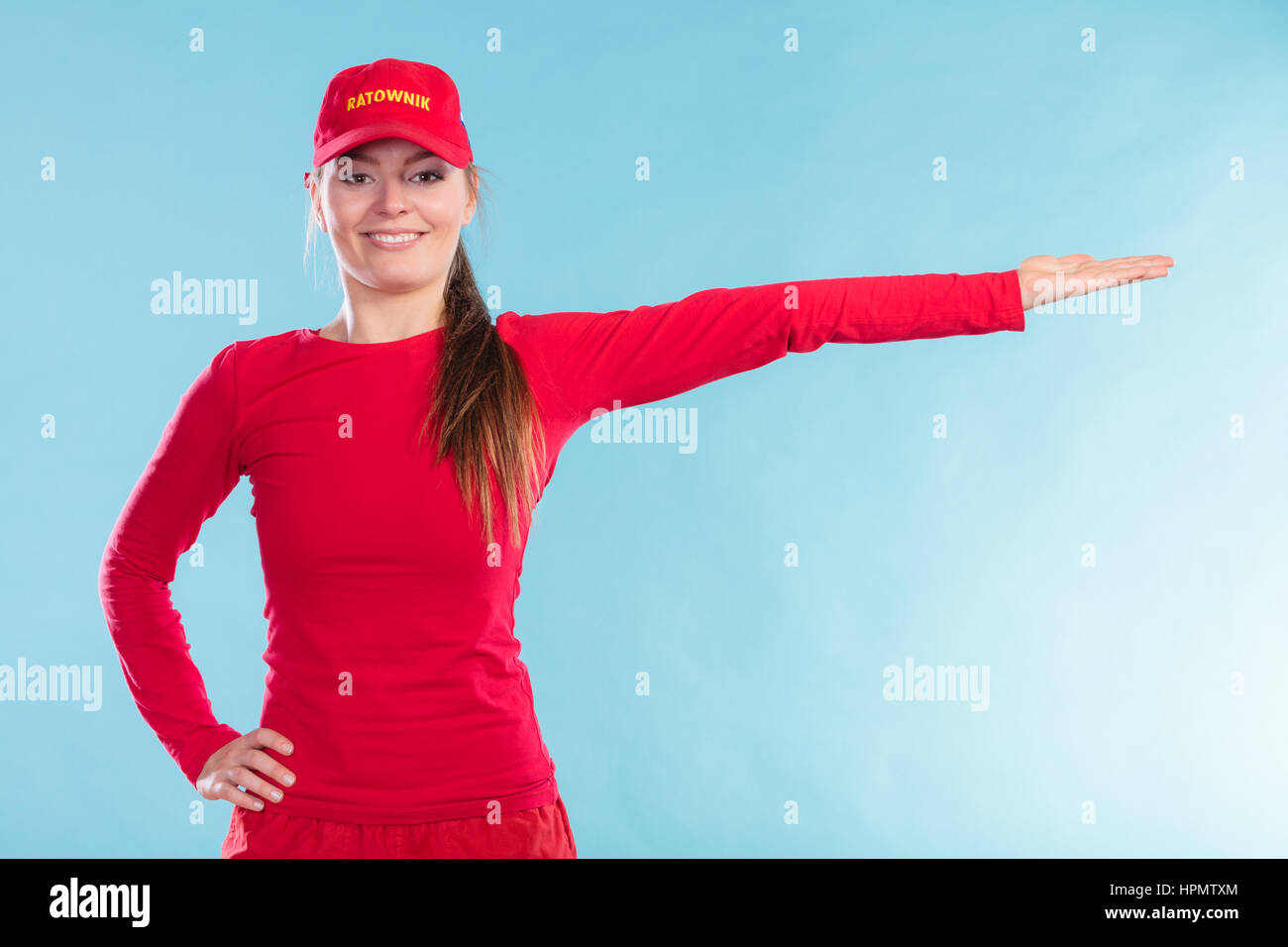Portrait of happy lifeguard woman girl in red cap with ratownik sign ...