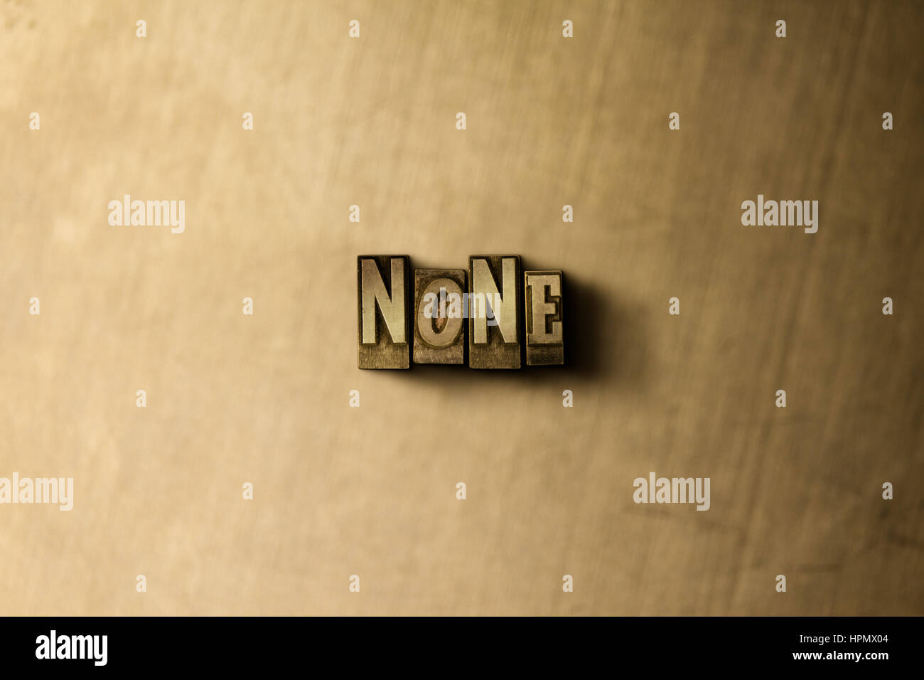 NONE - close-up of grungy vintage typeset word on metal backdrop ...