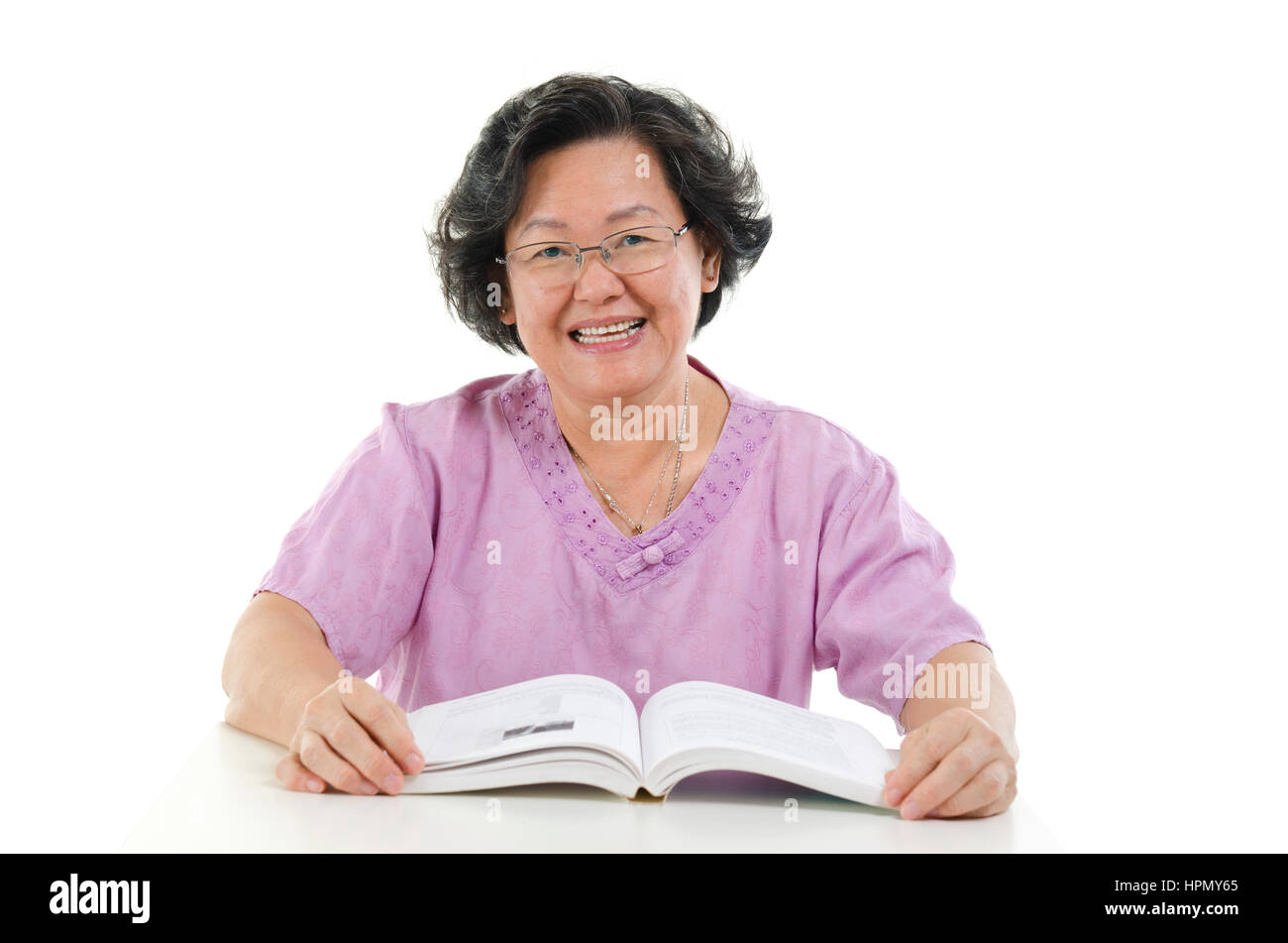 Older asian woman reading book hi-res stock photography and images - Alamy