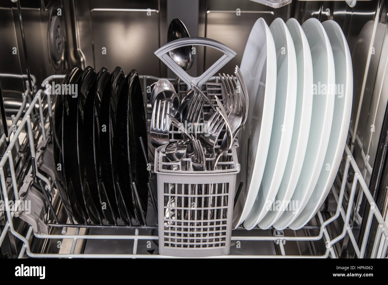 Clean dishes after washing in modern dishwasher machine Stock Photo - Alamy