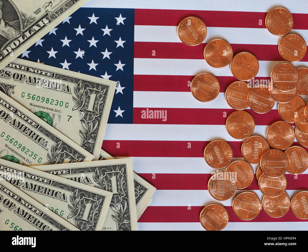 One Dollar banknotes and One Cent coins (USD) currency money over the ...