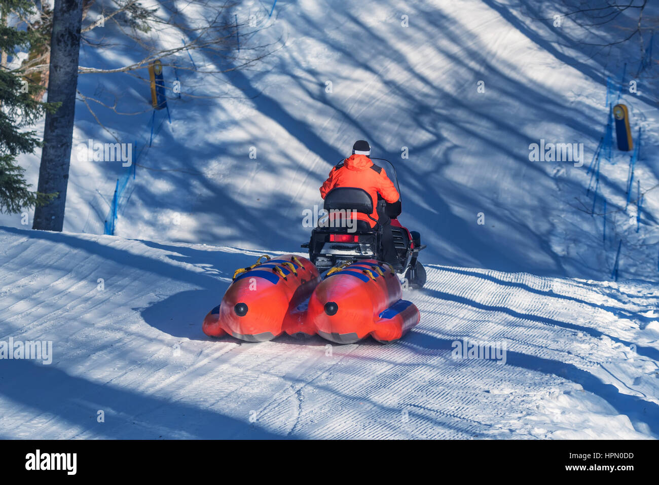 Red big banana catamaran boat for tubing dragging by snowmobile in ...