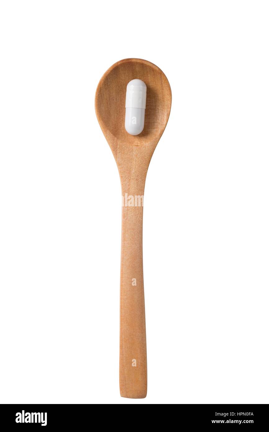 White capsule on a wooden spoon isolated on the white background Stock ...