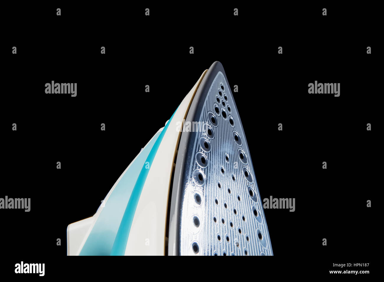White modern iron isolated on black background Stock Photo - Alamy