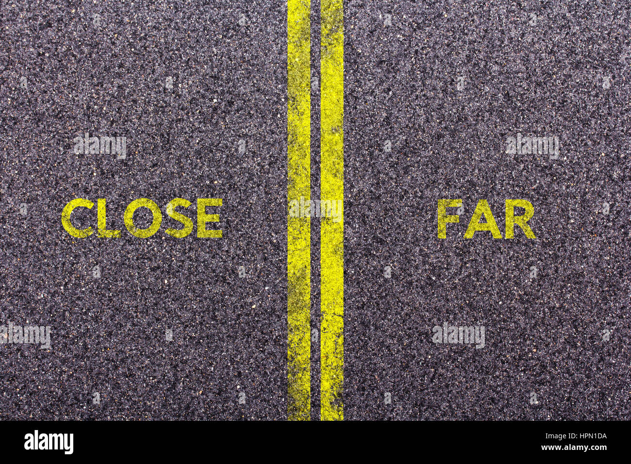 Tarmac background with the words close and far Stock Photo - Alamy