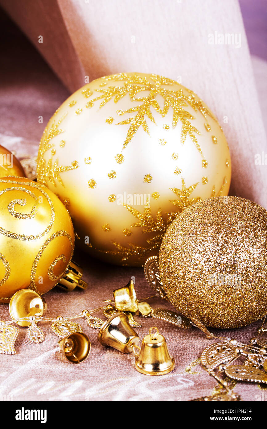 Festive gold Christmas decorations on a fabric background Stock Photo ...