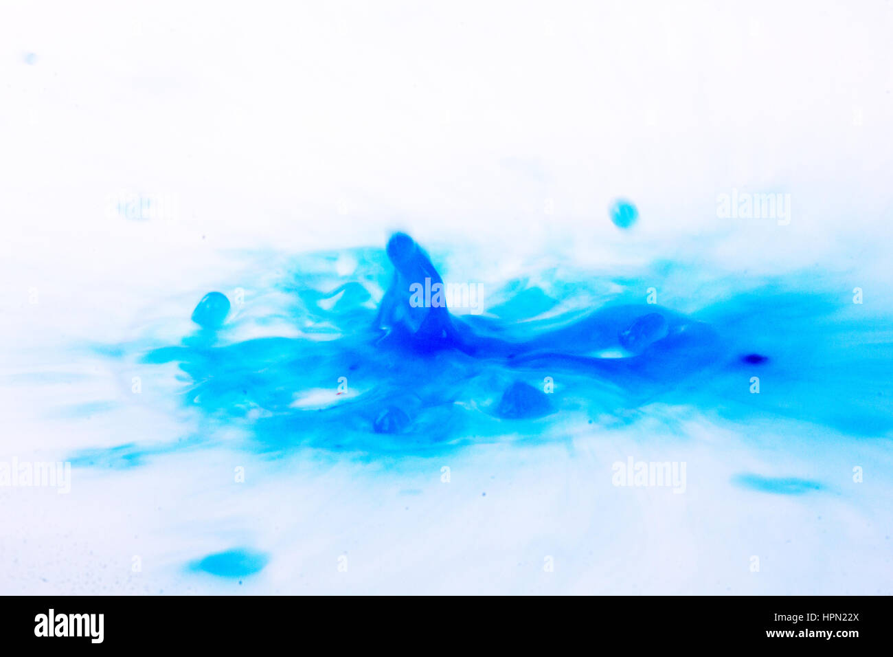 Colorful paint drop splashing on black a background Stock Photo - Alamy
