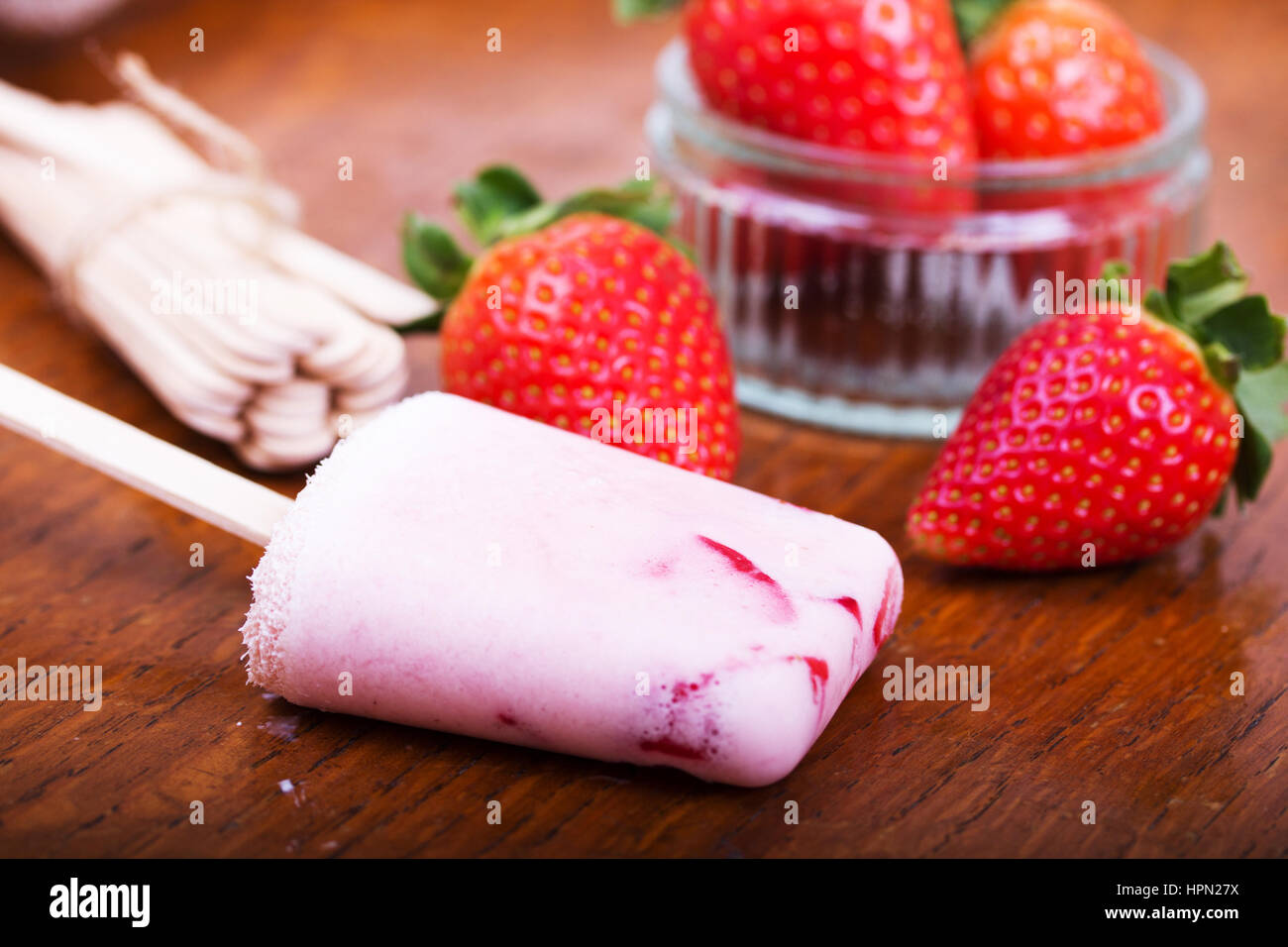 Homemade strawberry ice lolly on a rustic background Stock Photo - Alamy