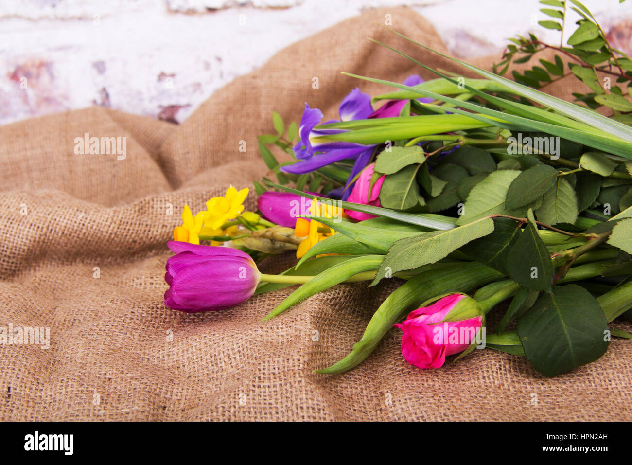 Spring cut flower arrangement against a rustic background Stock Photo ...