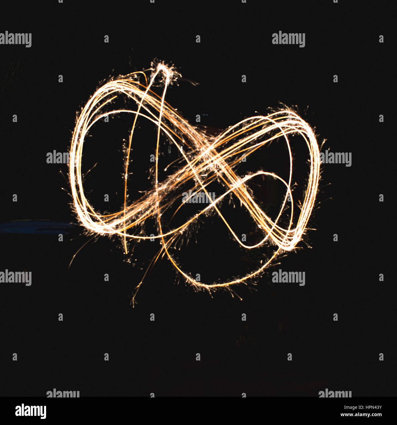 infinite shape made with a sparkler in a garden, using long exposure ...
