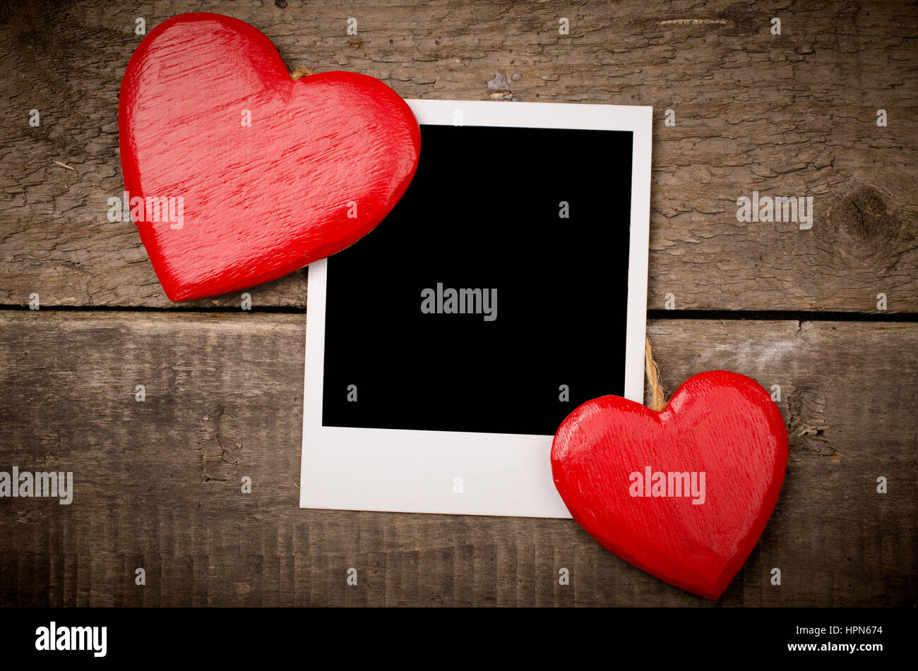 Two red wooden heart shapes with an old photograph Stock Photo - Alamy