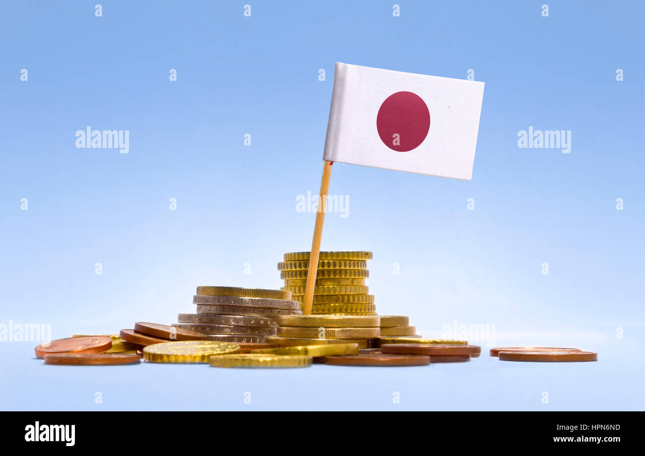 Flag of Japan in a mixed stack of european coins and a blue background ...