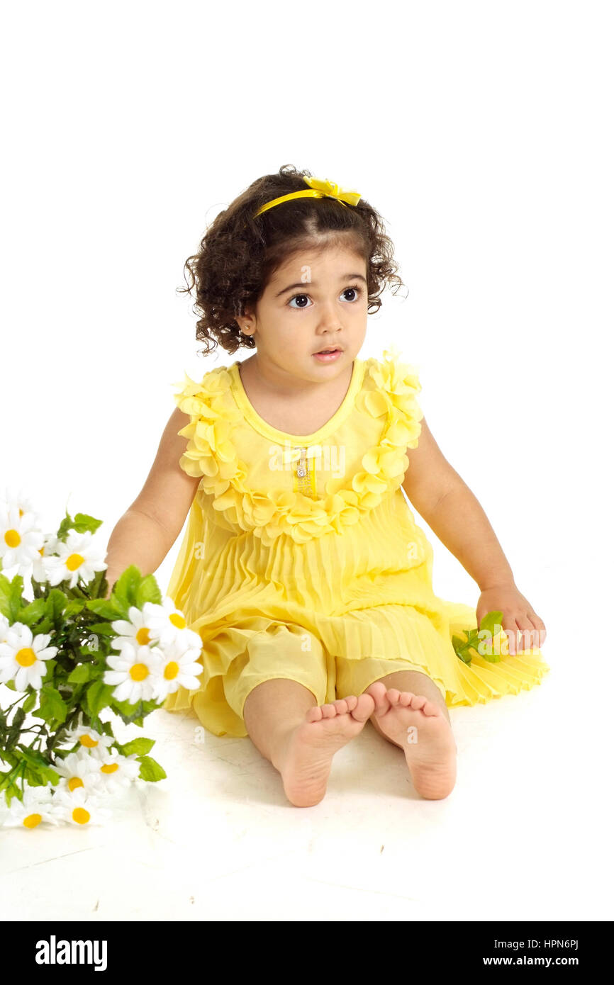 little girl in a yellow dress with flowers on a white background Stock ...