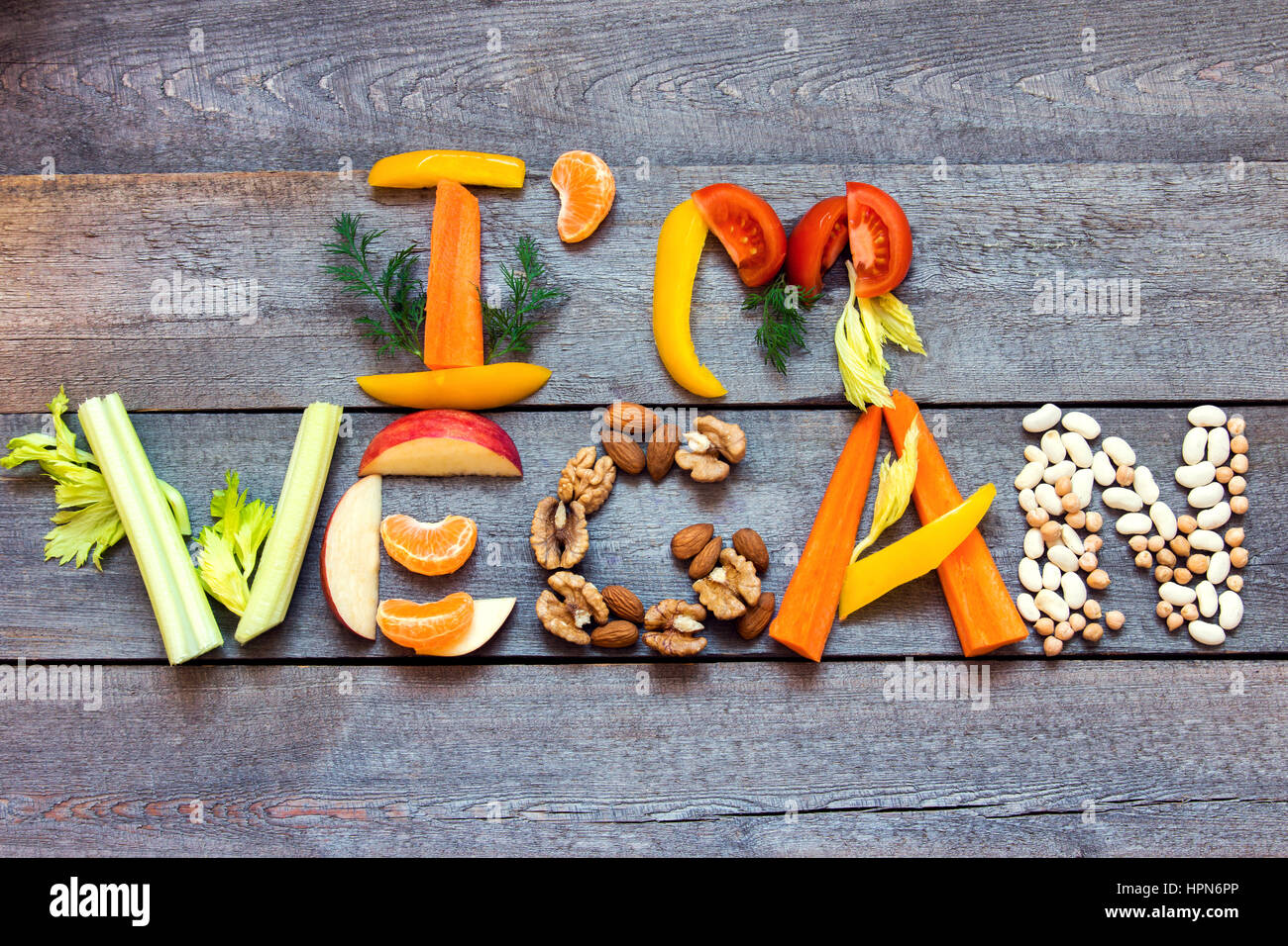Words "I'm Vegan" written with vegetables, fruits, nuts and legumes on ...